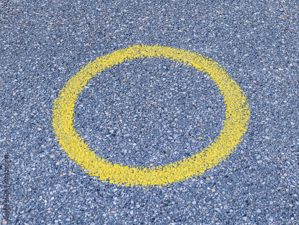 Yellow spray paint is used as a circular symbol to mark a point of ...