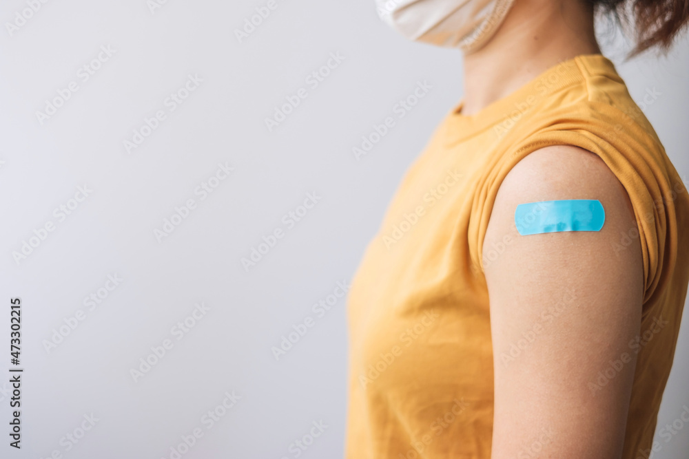 woman showing bandage after receiving covid 19 vaccine. Vaccination ...