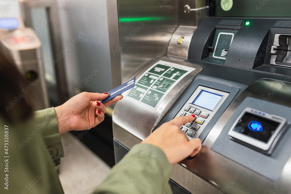 Woman making payment through smart card in subway Stock Photo | Adobe Stock