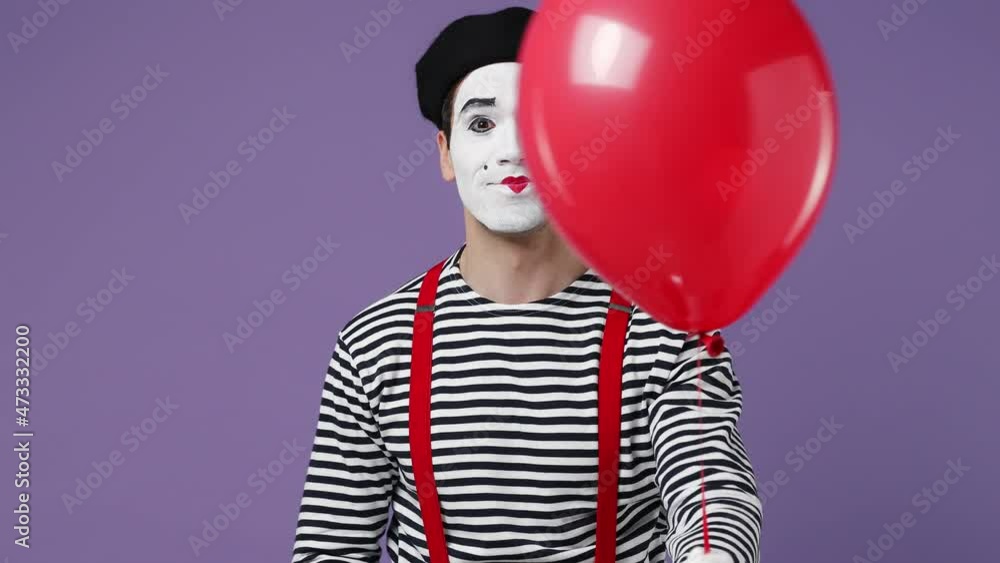 Charismatic fun young mime man with white face mask wears striped shirt ...