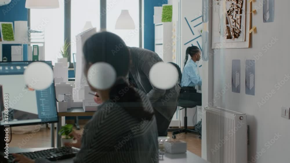 Man engineer working with building model and blueprints to plan urban ...