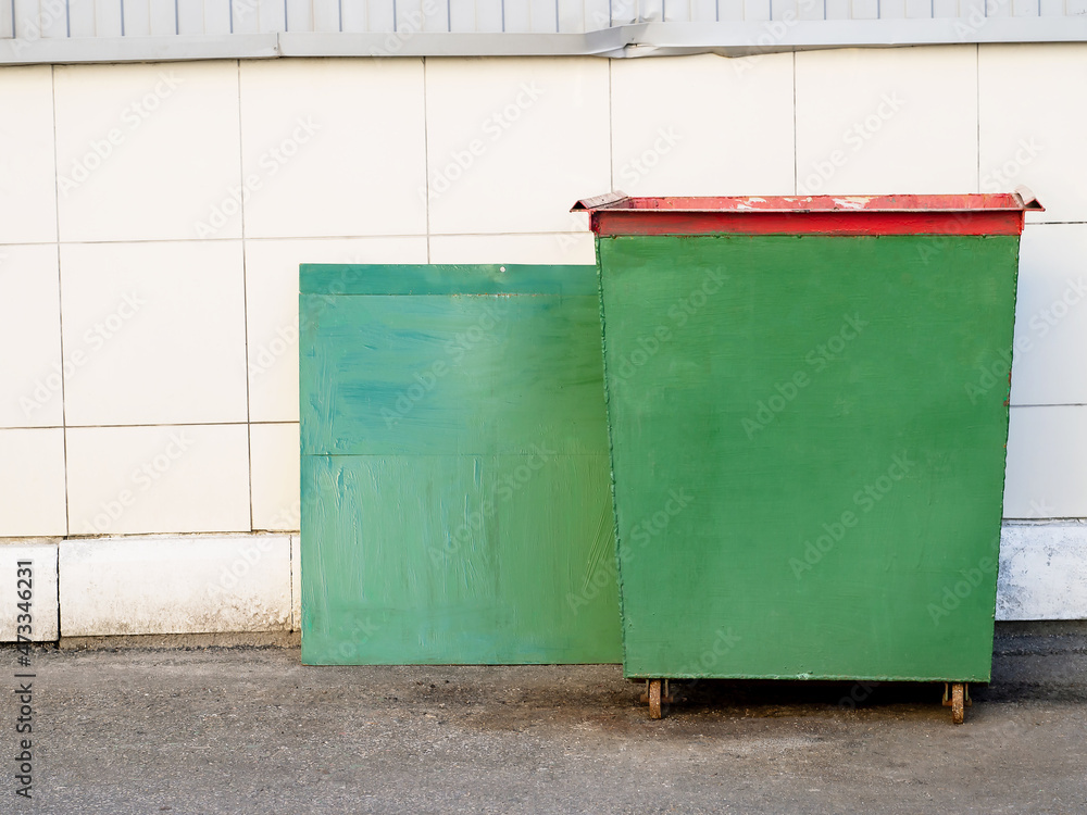 Urban trash green container standing on the street. Concept: Waste ...