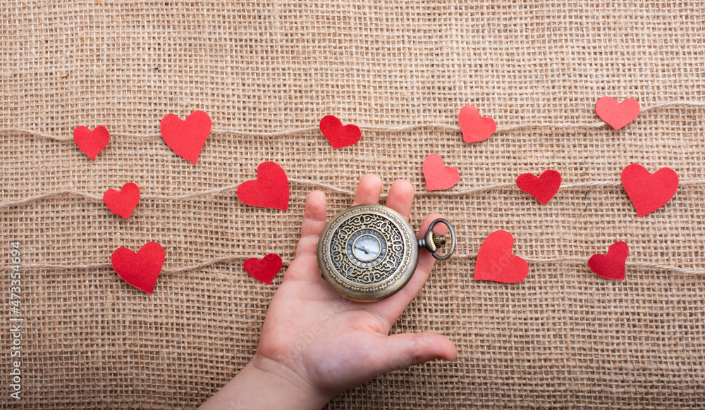Love concept with pocket watch and heart shaped icons Stock Photo ...