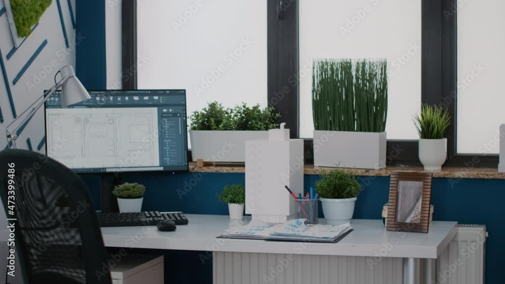 Close up of monitor with digital blueprints plans on desk for ...