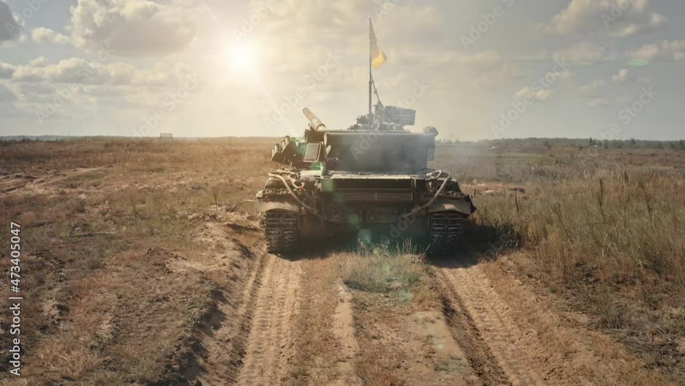 Military tank shooting fire on battlefield. Rocket launchers fire from ...