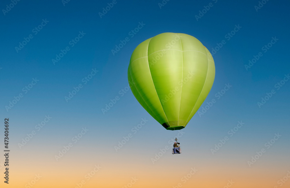 Green hot air balloon in flight Stock Photo | Adobe Stock