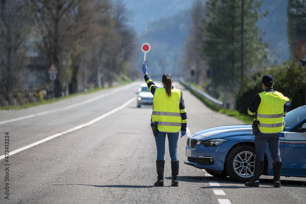 Italian Police controls on the road. Officers with masks and gloves ...