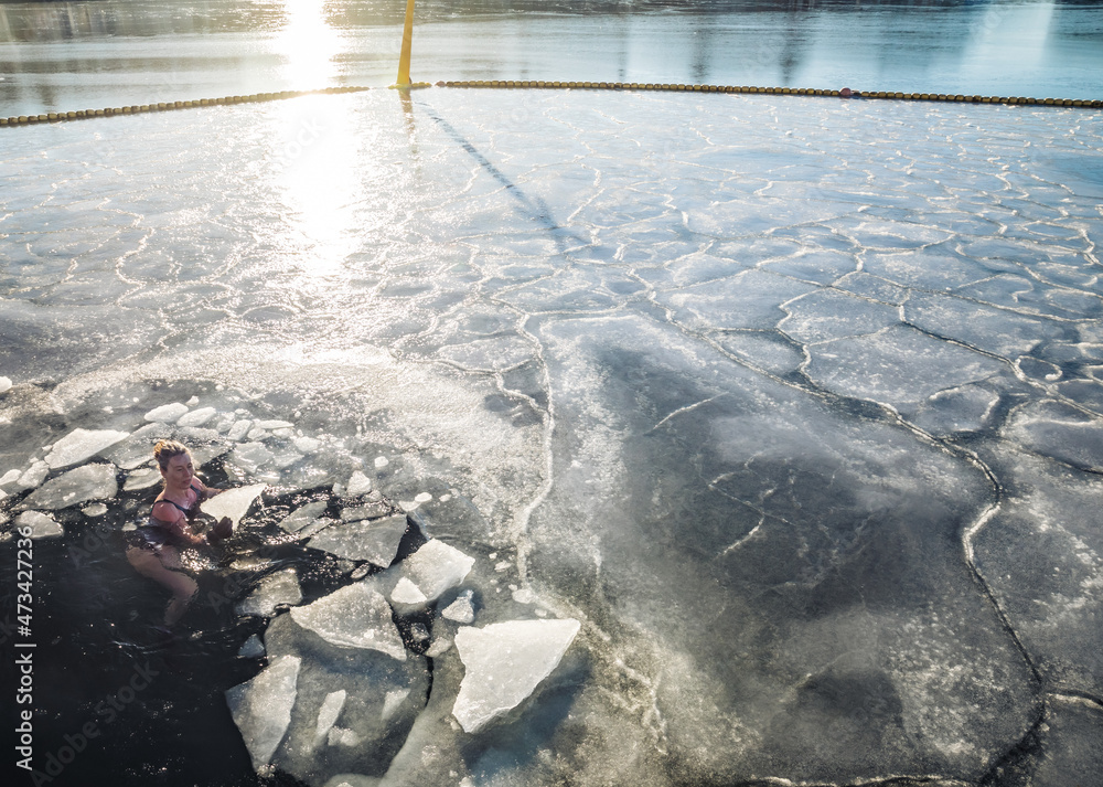Woman Holding Solid Ice While Floating In Frozen Ocean in Denmark Stock ...