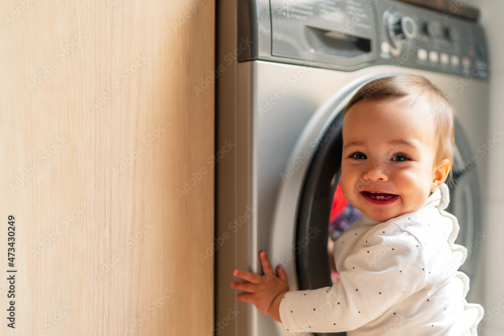 little girl laughing with washing machine Stock Photo | Adobe Stock