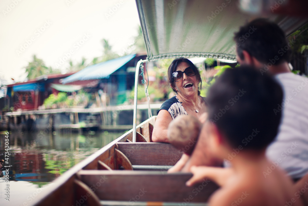 Laughing woman on a boat at a floating market in Bangkok Thailand ...