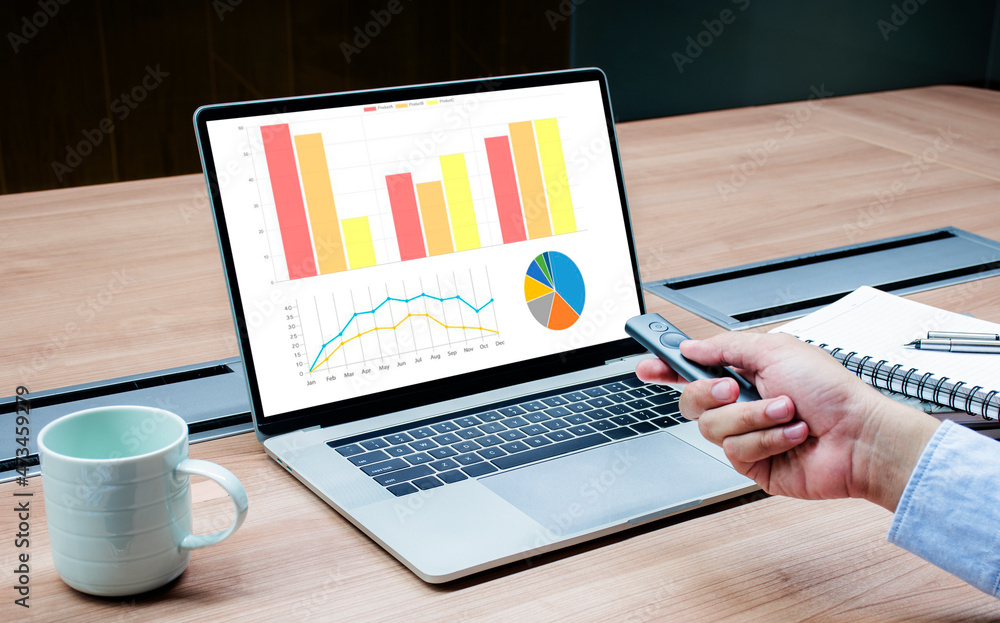 Businessman hand hold remote control slide with mock up chart slide ...