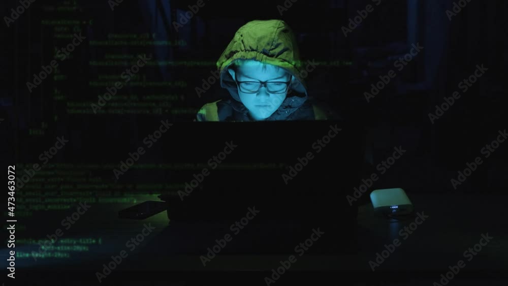 Young Boy Hacker Typing On Laptop With Security Codes Moving In The ...
