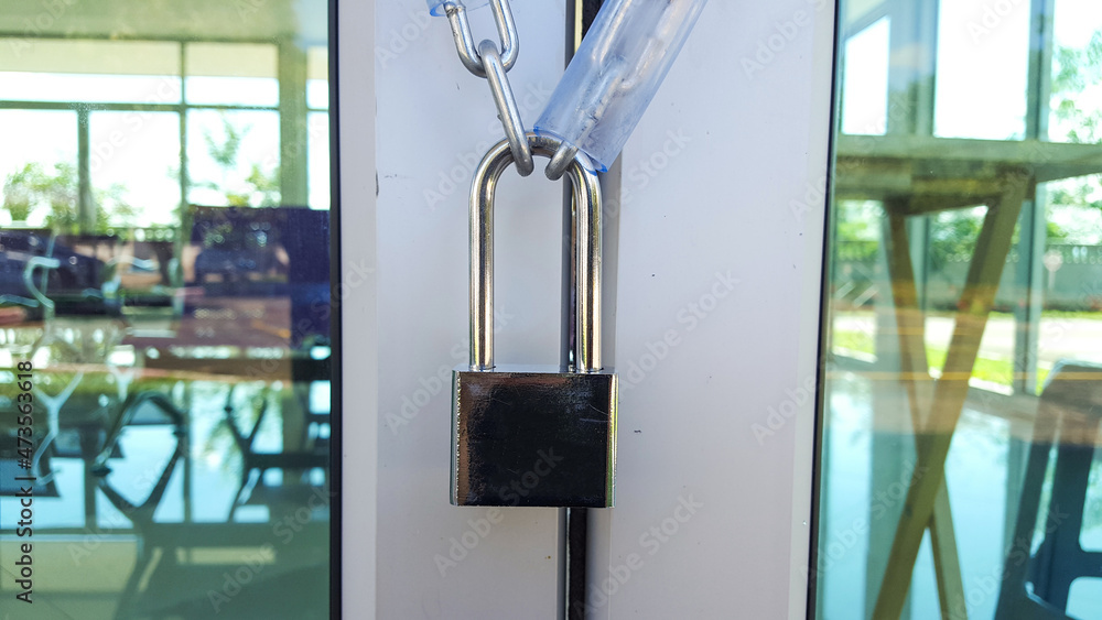 Silver shining metal lock pad hanging with rubber tubed metal chains ...