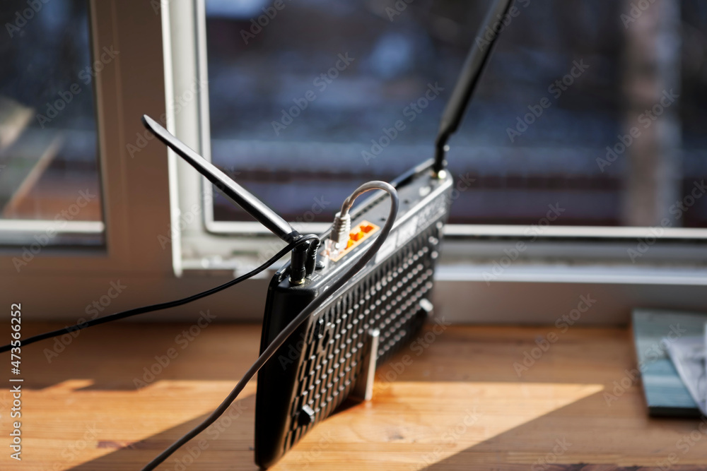 wi-fi router on a window Stock Photo | Adobe Stock