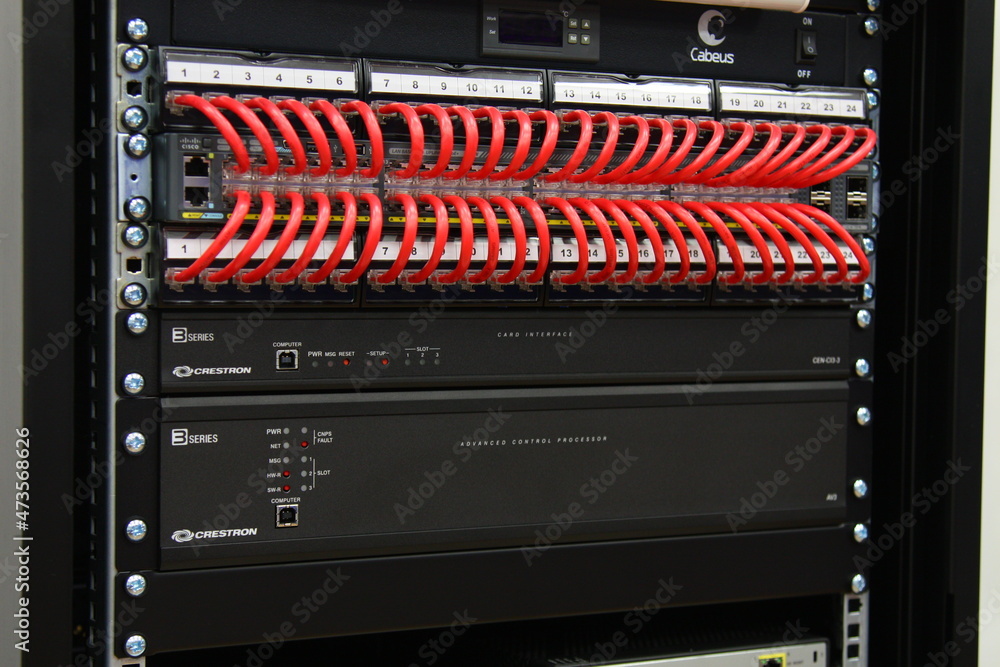 Ethernet switches are connected to patch panels using colored patch ...