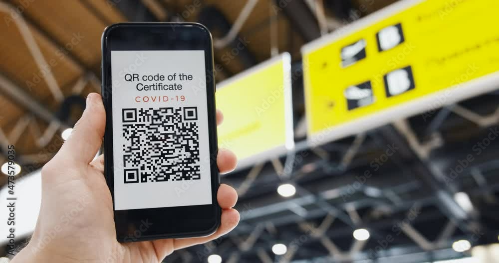 Hand showing QR code in the airport on the screen of smartphone mobile ...