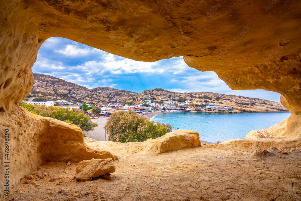 Matala beach with caves on the rocks that were used as a roman cemetery ...