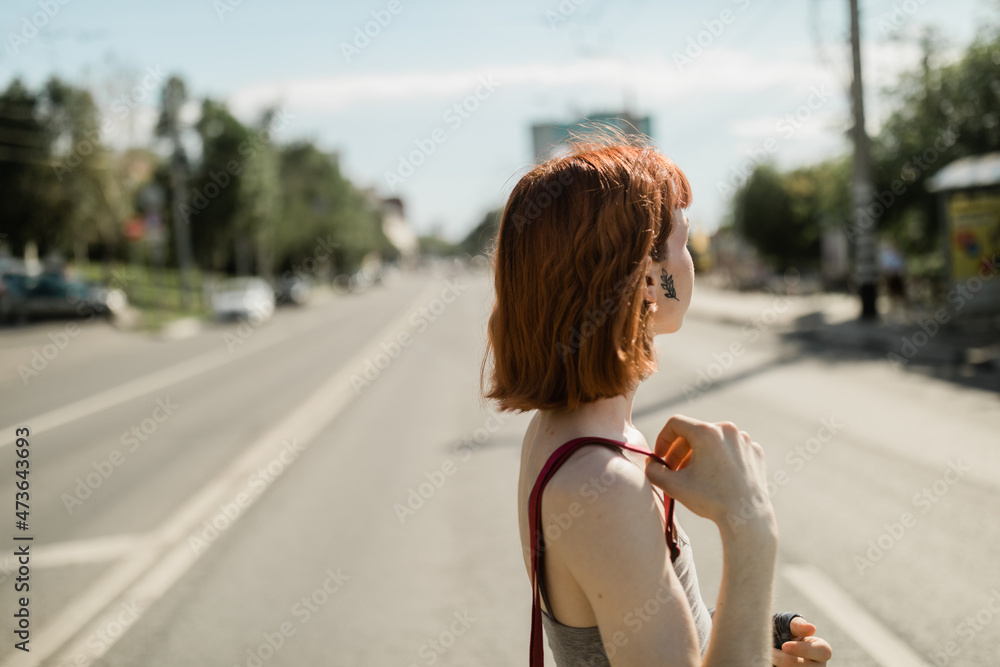 Young transgender woman walking outdoors Stock Photo | Adobe Stock