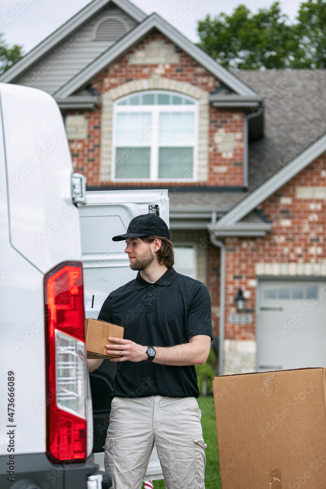 Shipment: Man Putting Box Onto Stack On Dolly Stock Photo | Adobe Stock