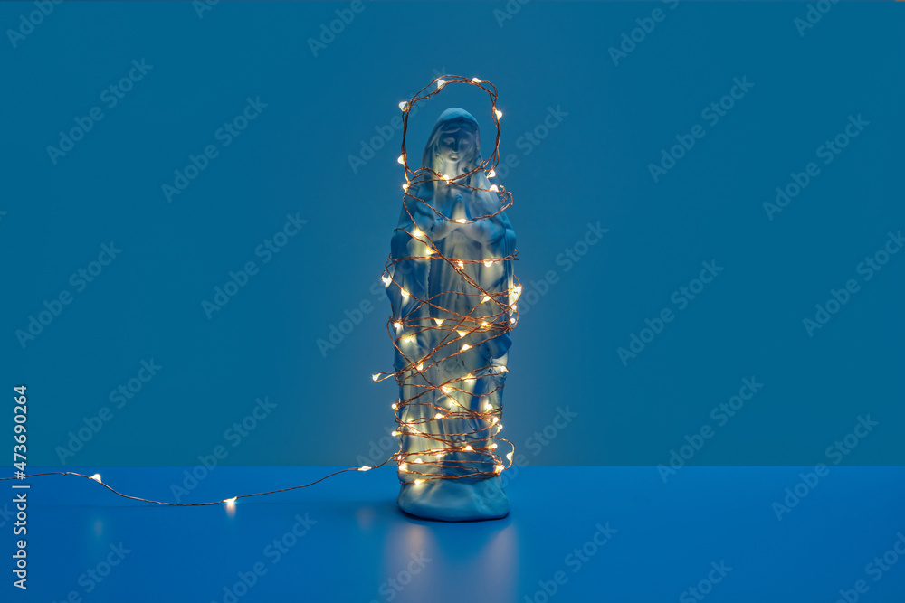 Praying Virgin Mary with glowing garland and halo Stock Photo | Adobe Stock