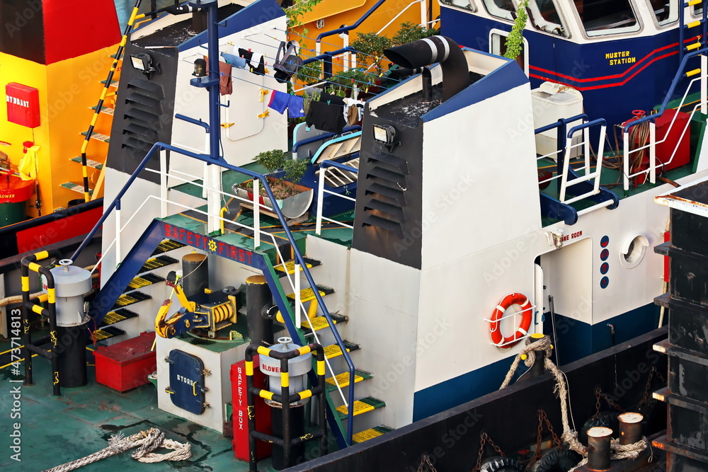 Various views of vessels and tugboats in port. Close-up view of the ...