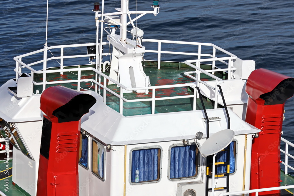 Various views of vessels and tugboats in port. Close-up view of the ...