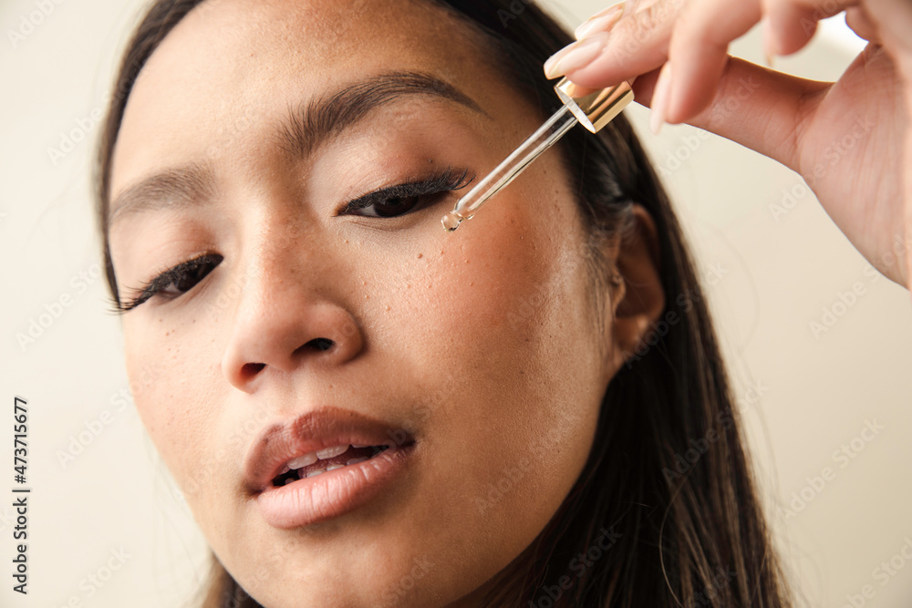 Beautiful model using face serum dropper Stock Photo | Adobe Stock