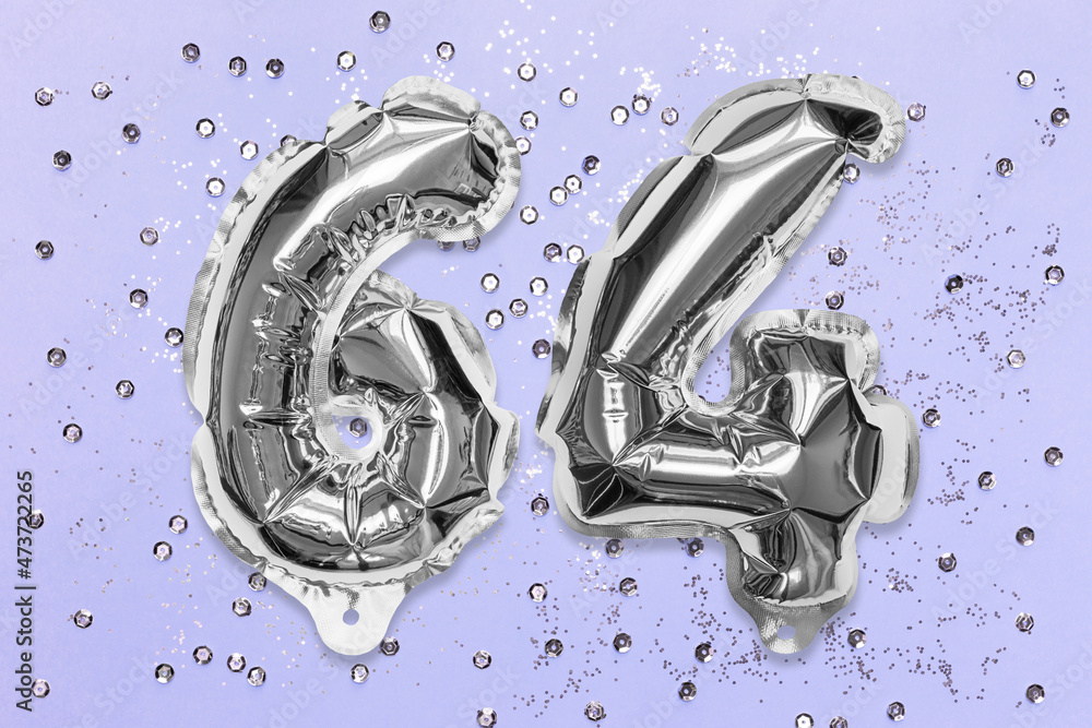 Silver foil balloon number, digit sixty four on a lilac background with ...