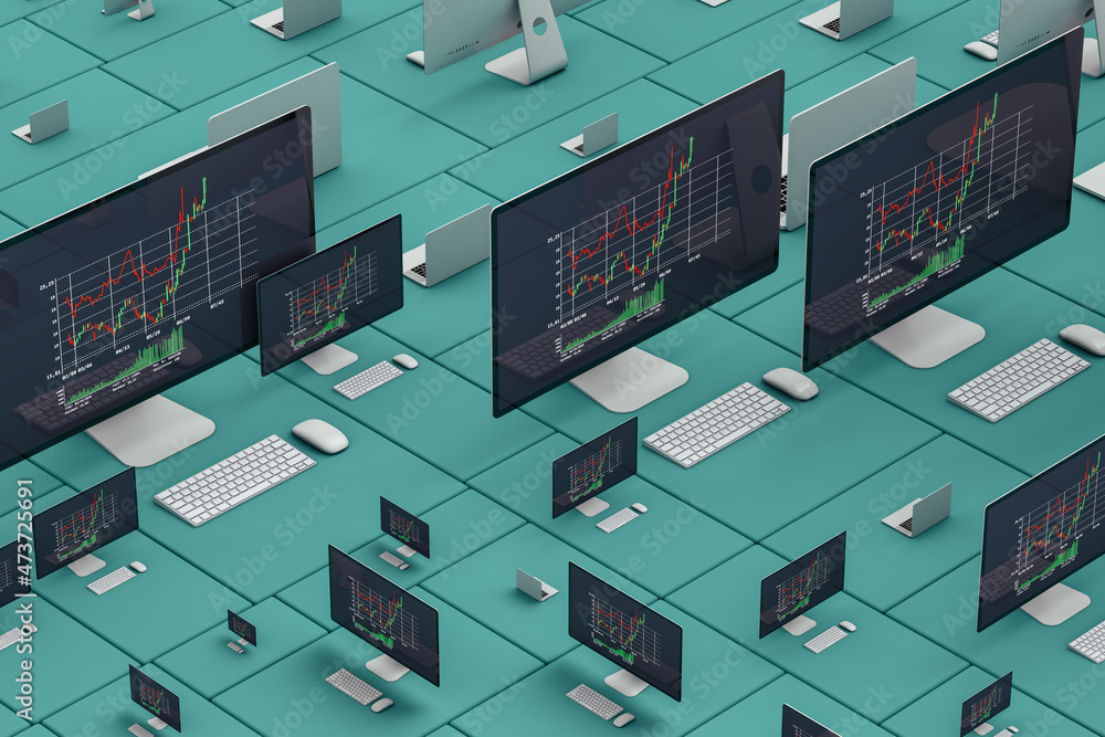 Laptop and desktop computer showing stock market statistics on screen ...
