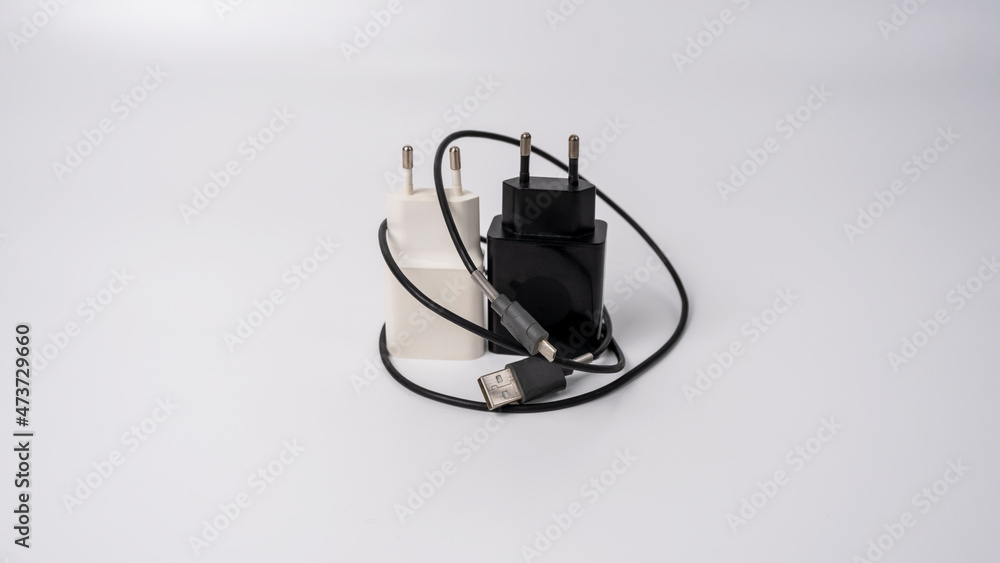 This is a black and white smartphone charger on a white background. It ...