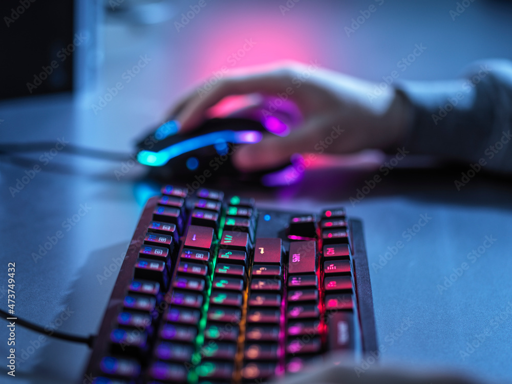 Boy playing game with gaming mouse and keyboard Stock Photo | Adobe Stock