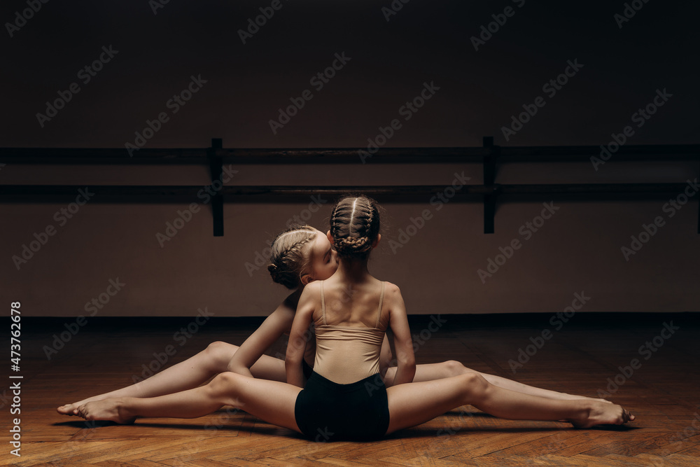 Image of two beautiful young ballerinas doing the splits, stretching ...
