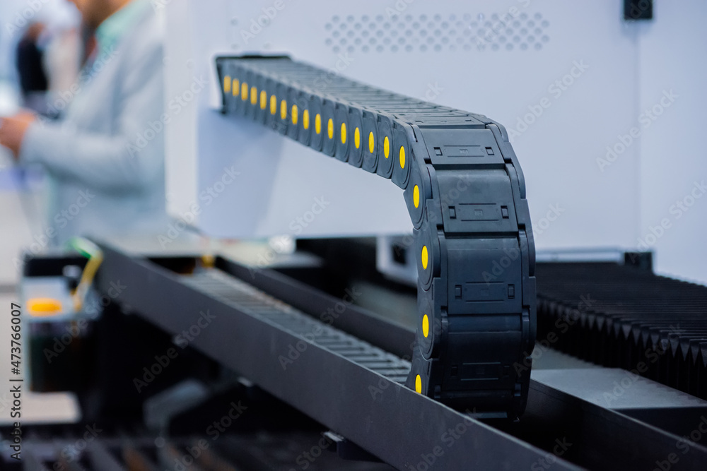 Plastic cable chain of electrical wires in the machine. An example of a ...