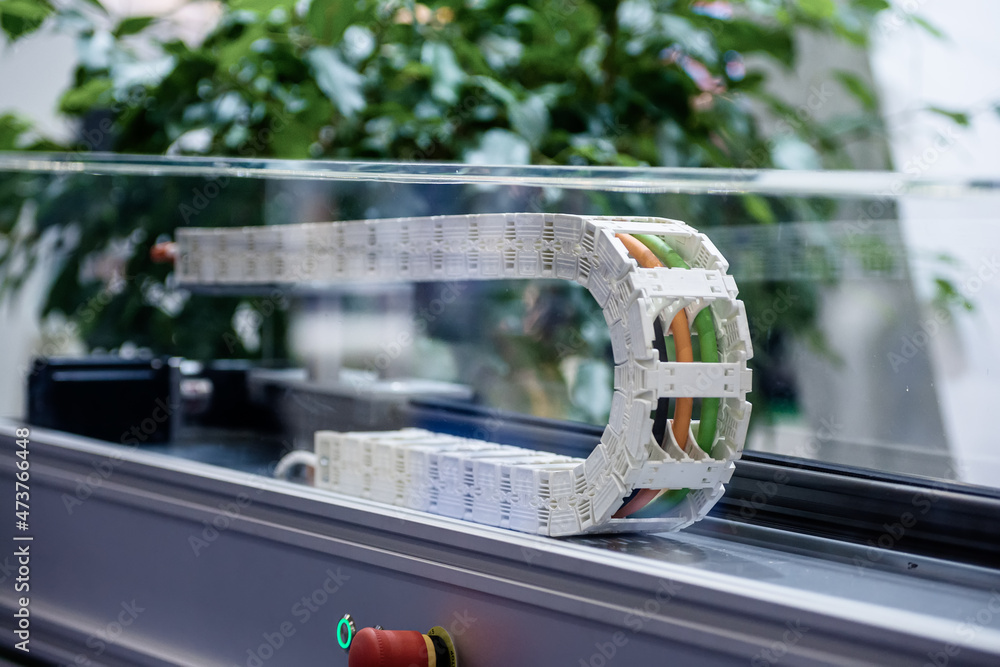 Plastic cable chain of electrical wires in the machine. An example of a ...