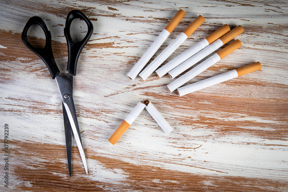 Scissors cut a cigarettes. Addiction, health and treatment concept ...