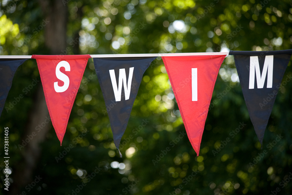 swim banner pennant signage hanging outdoors, close-up and full frame ...