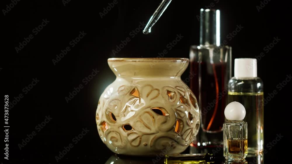 Dripping oil from pipette into vase close-up. Making aroma serum on ...