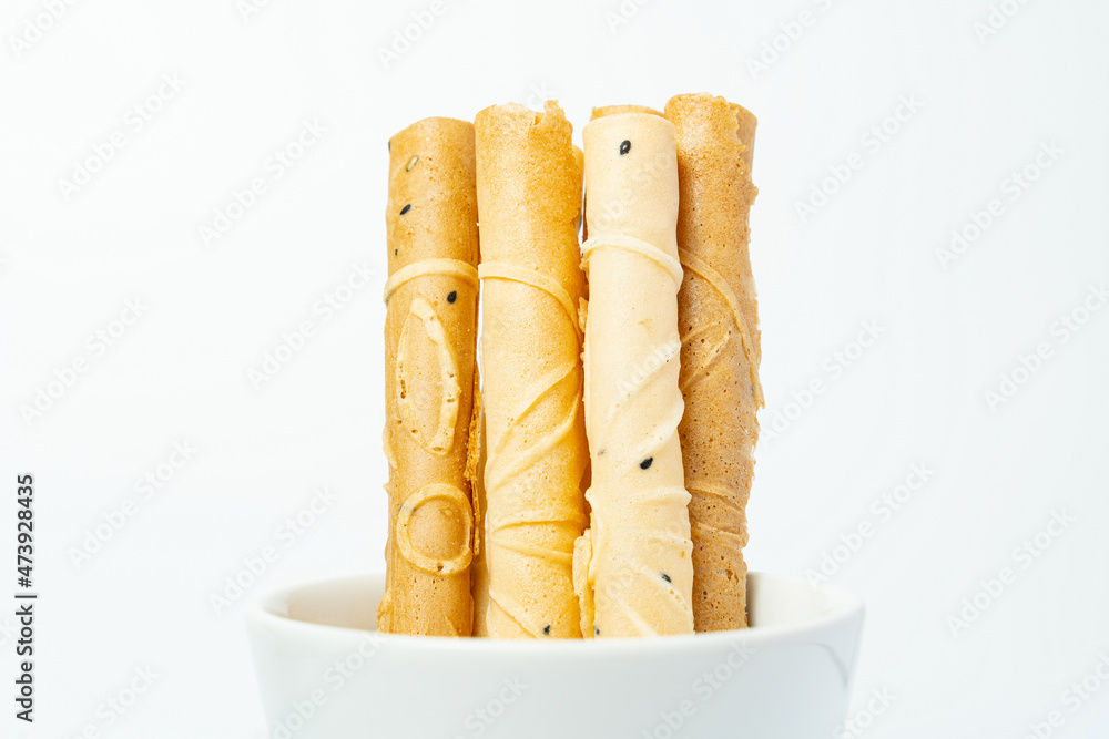 Thai crispy dessert roll isolated on white background. Close up of Tong ...