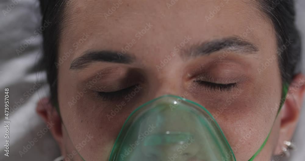 Extreme close-up of a young brunette woman opening her eyes in a ...