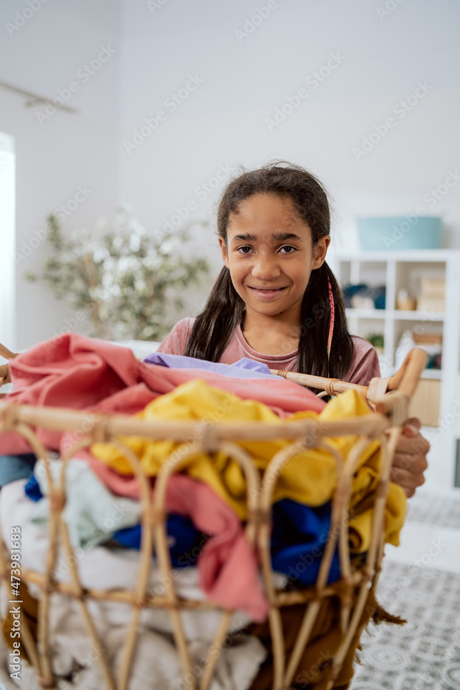 Smiling pretty girl stands in the middle of the bathroom, laundry room ...