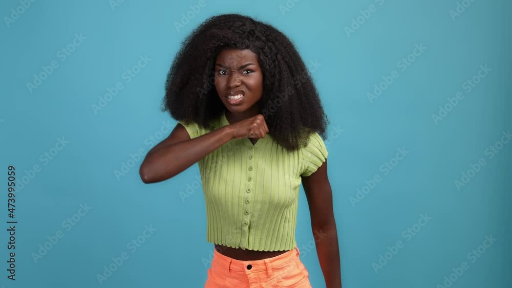 Outraged lady show sign cut hand neck yell isolated blue color ...