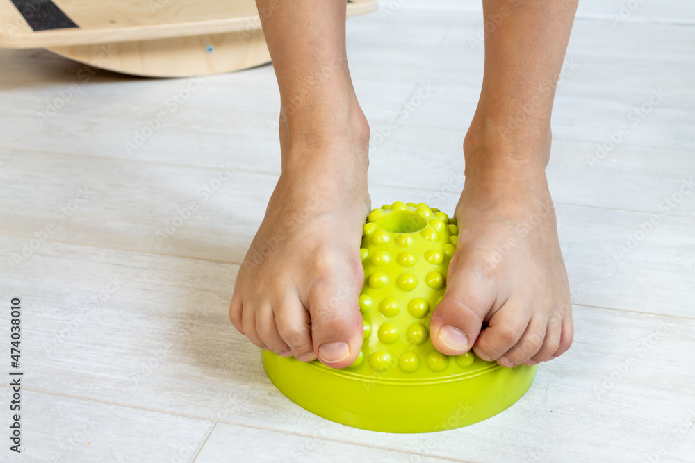 The child performs exercises on the balancer from the valgus of the ...