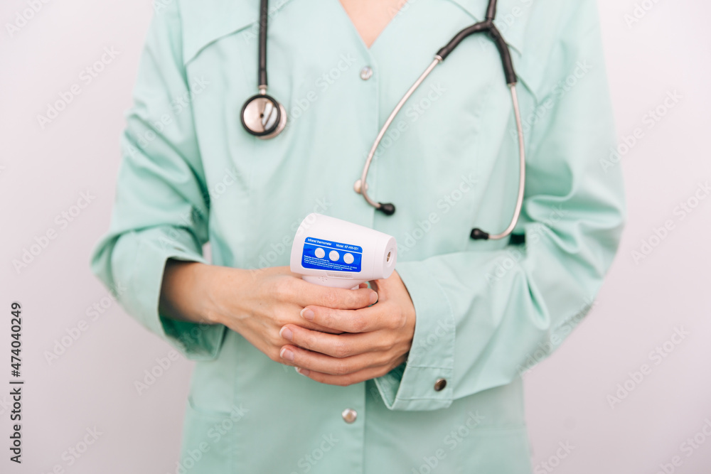 Temperature measurement gun in doctor hands. Close-up shot of doctor ...