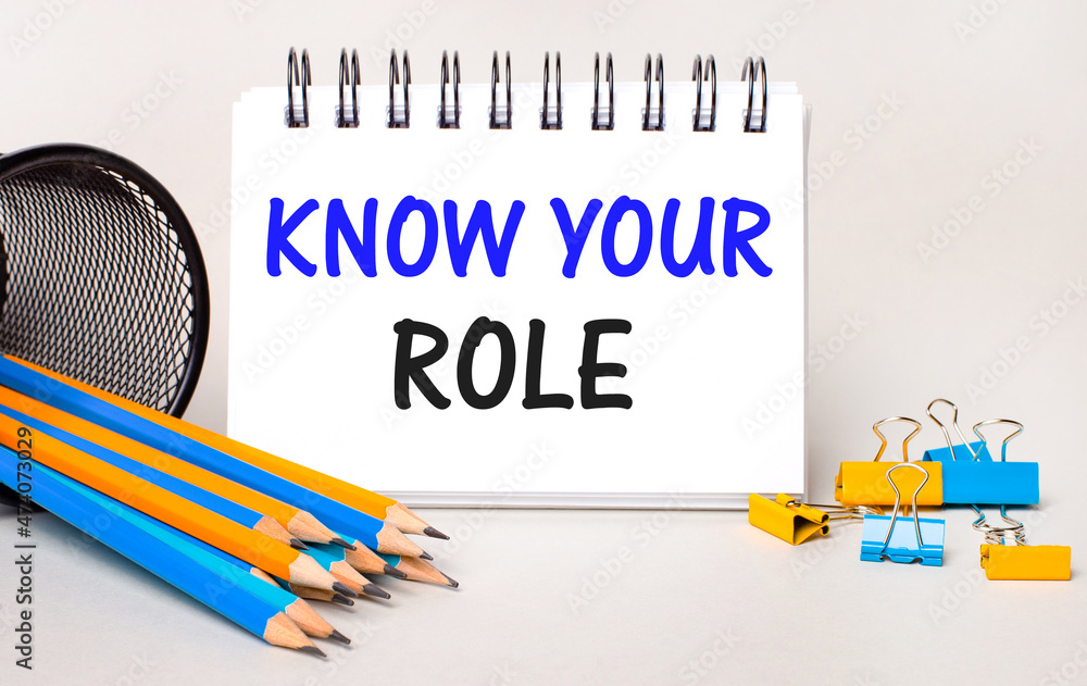 On a light background, yellow and blue pencils and paper clips and a ...