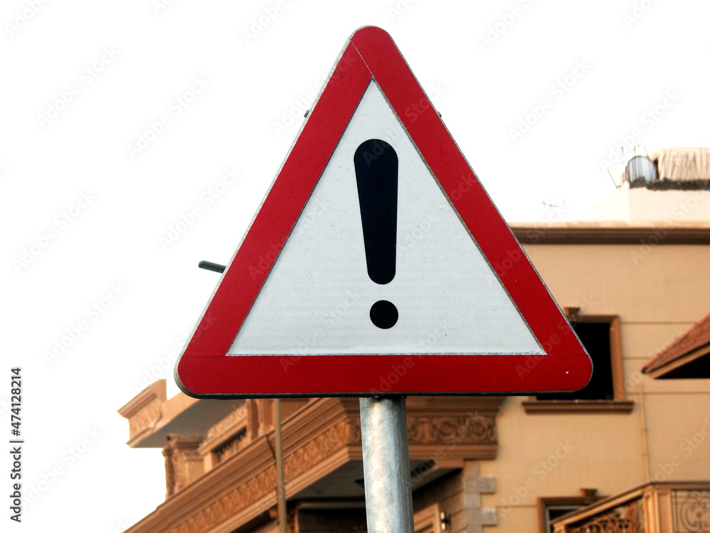 Red exclamation attention sign, danger red triangle road sign next to ...