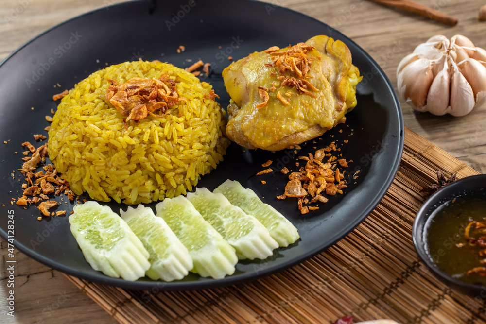 Rice with curried chicken. Delicious spicy chicken biryani in black ...