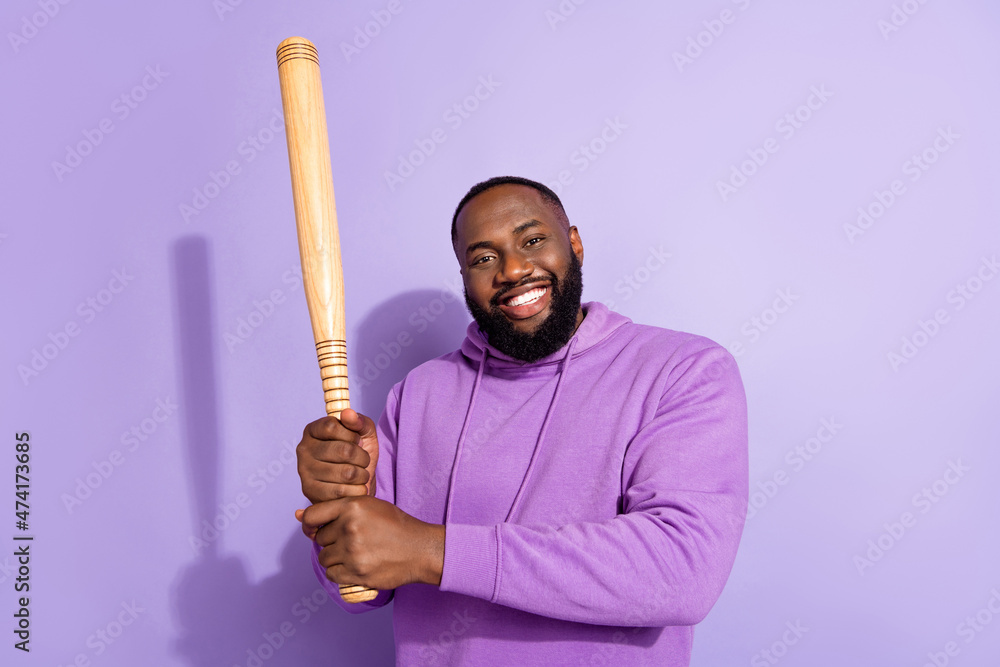 Portrait of attractive cheerful confident strong guy holding bat match ...