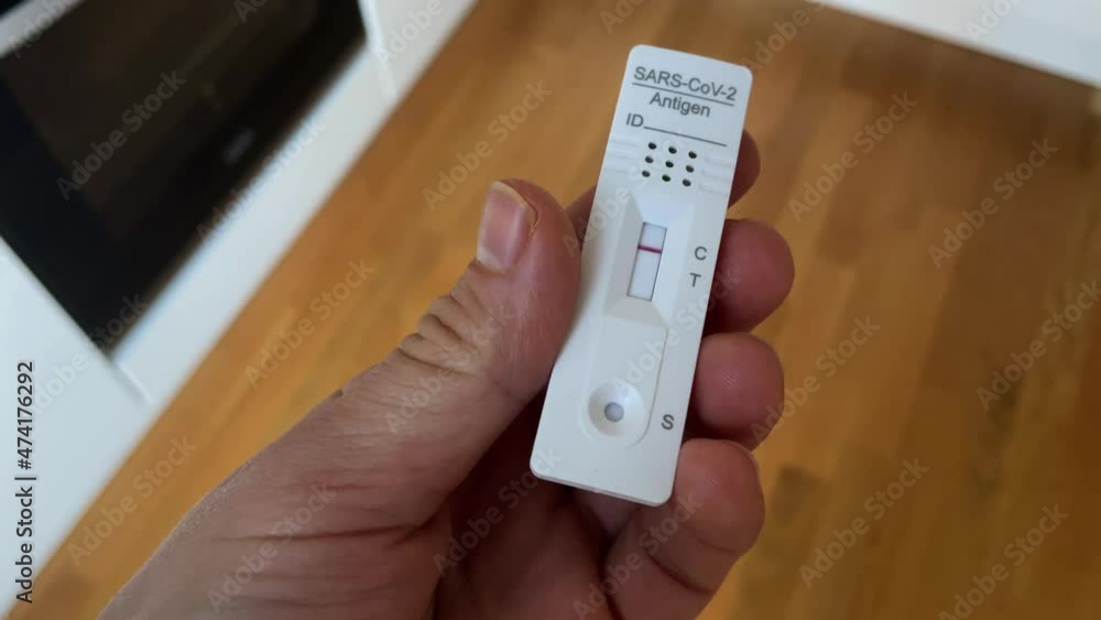 Close up of hand view of person holding a negative self test of Covid ...