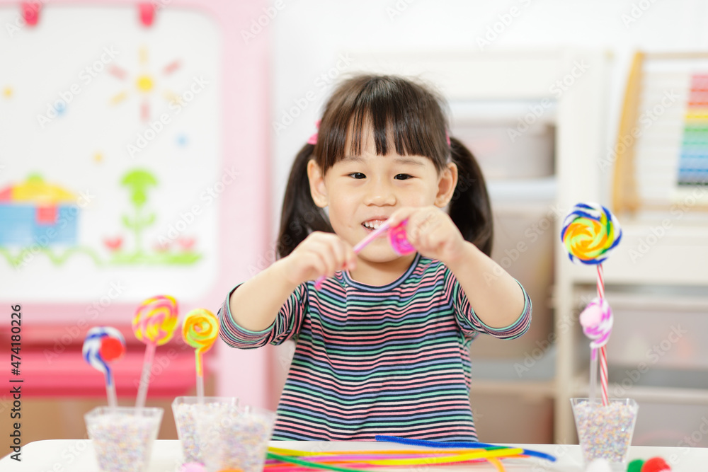 young girl making craft for homeschooling Stock Photo | Adobe Stock