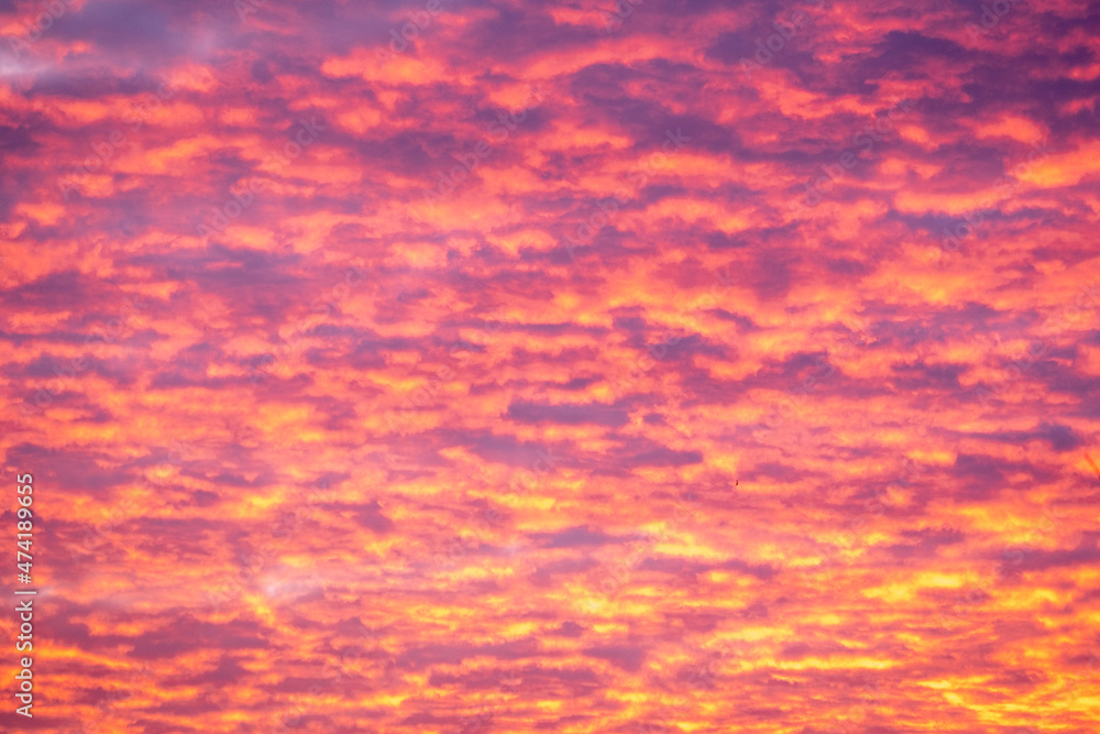 bright pink and orange puffy clouds in the sky during sunrise or sunset ...